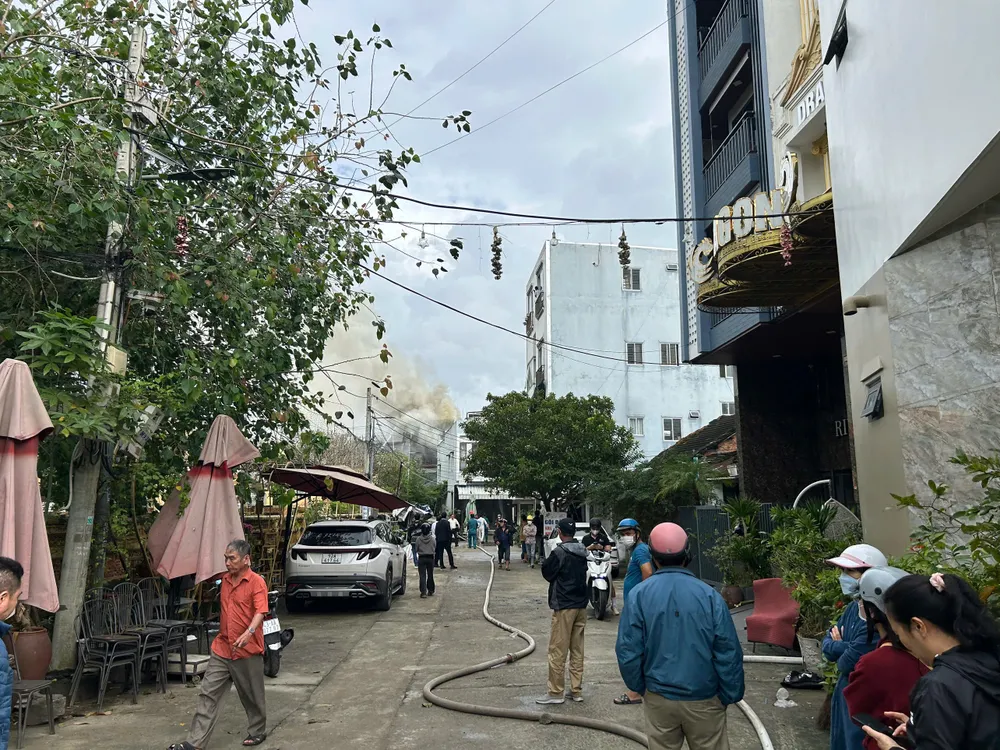 Firefighters are working to control a fire in a high-rise building in a ...