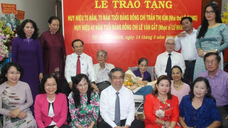 Awarding the Party Badge to poet Le Giang and musician Lu Nhat Vu
