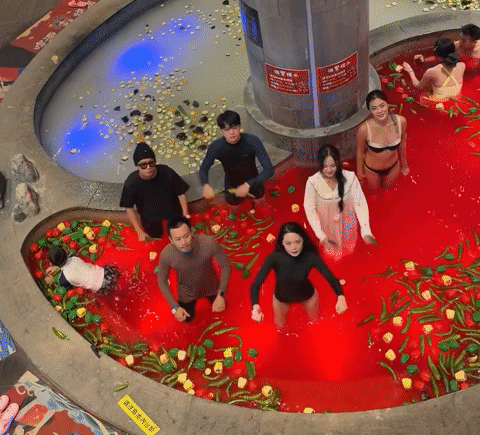 Vietnamese tourists bathe in a giant 'hot pot' full of chili peppers ...